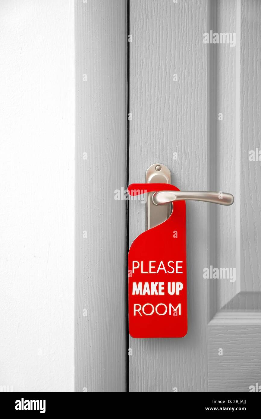 Closed door with sign PLEASE MAKE UP ROOM on handle at hotel Stock ...