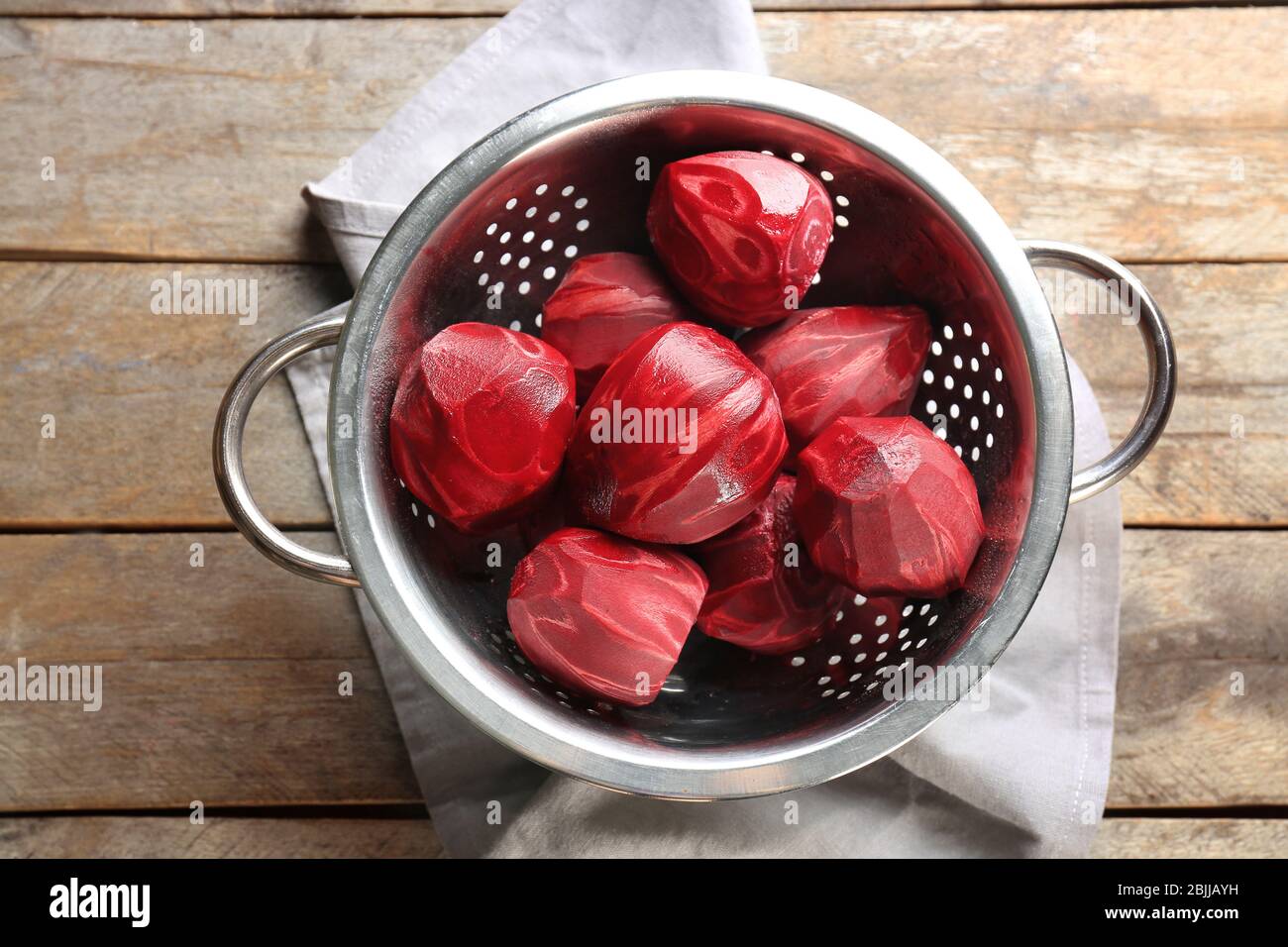 Peeled beets in strainer on wooden background Stock Photo - Alamy