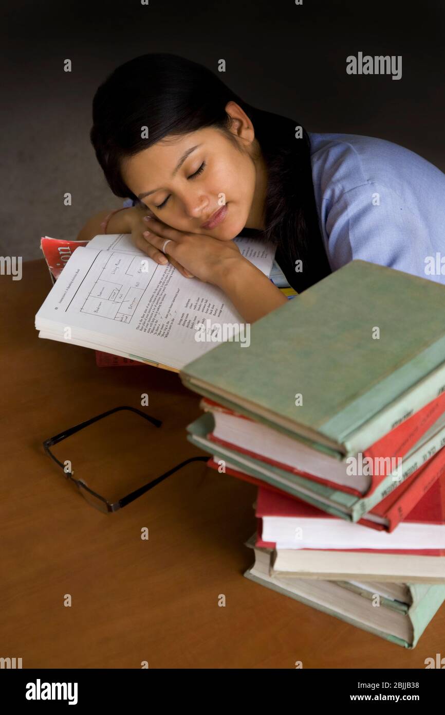 Girl sleeping in a library Stock Photo - Alamy