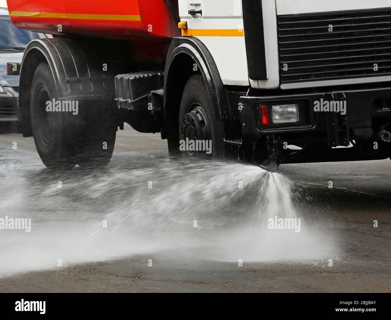 Municipal car for cleaning roads on city street Stock Photo - Alamy