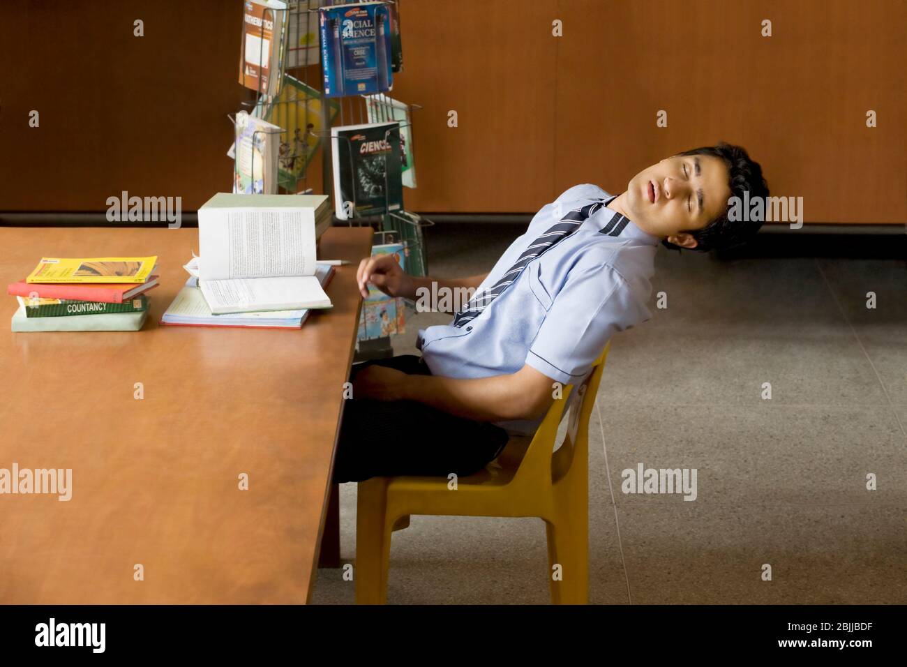 School boy sleeping on chair hi-res stock photography and images - Alamy