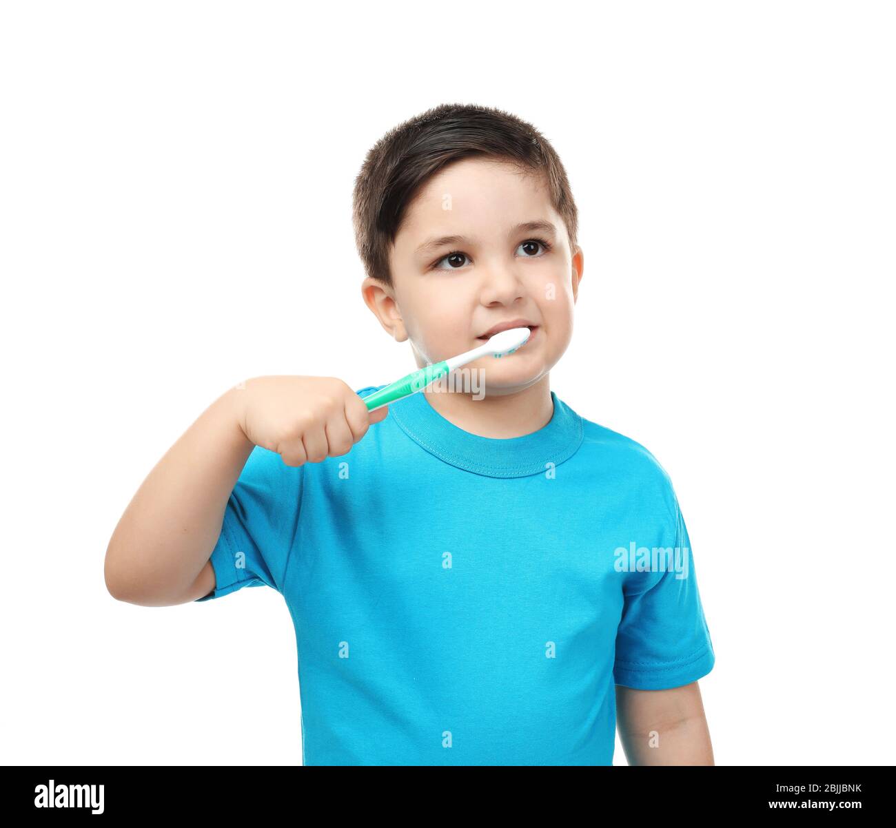 Cute little boy cleaning teeth on white background Stock Photo - Alamy