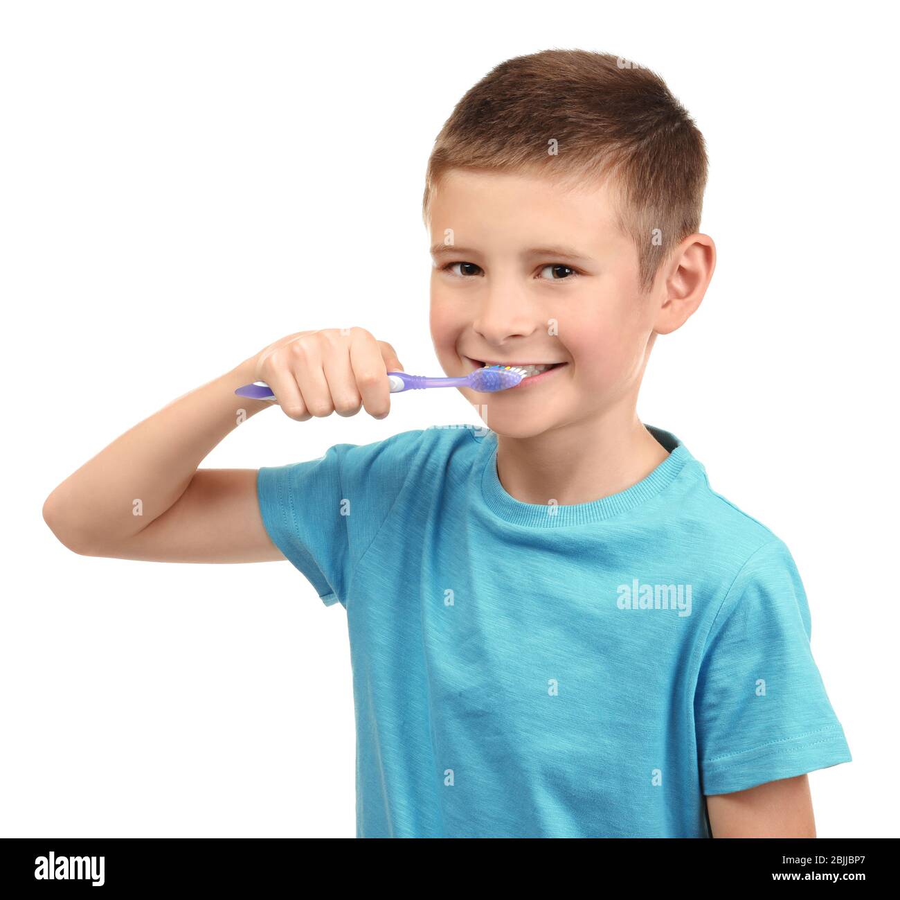 Cute little boy cleaning teeth on white background Stock Photo - Alamy