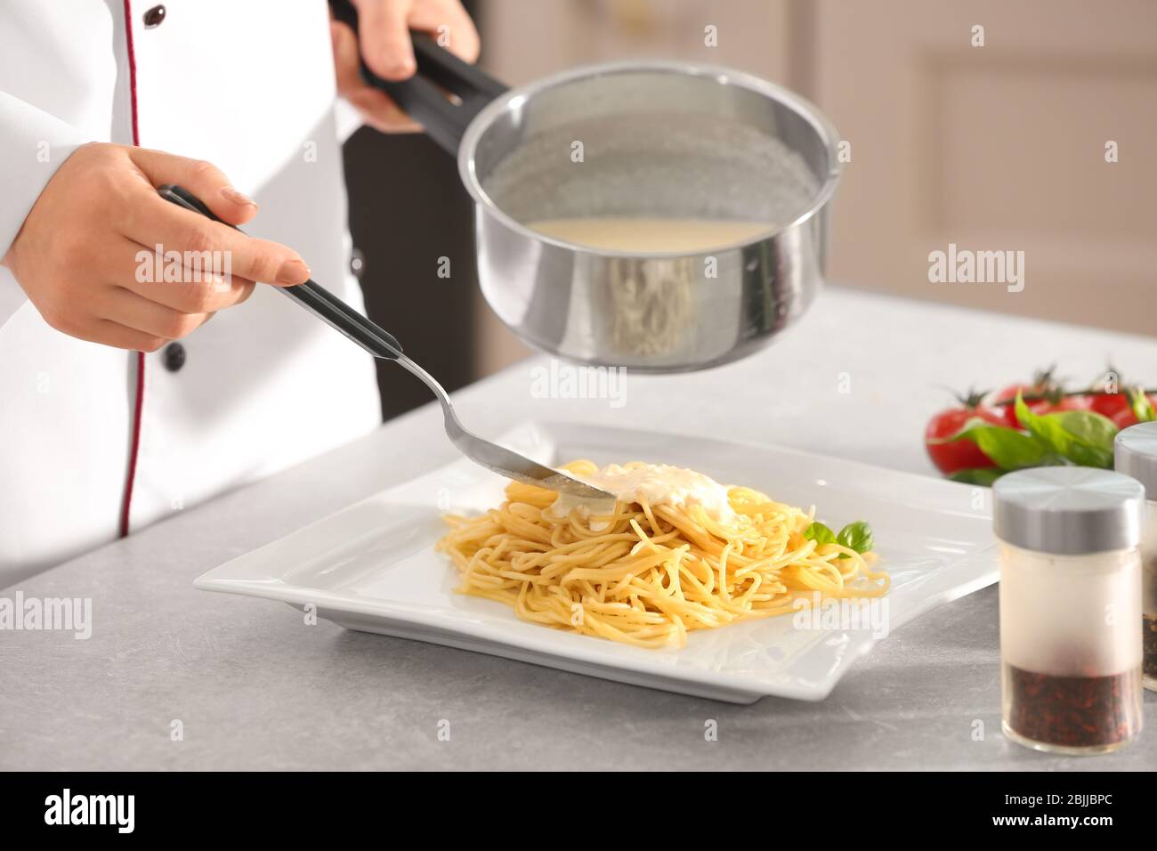 Woman adding white sauce pasta hi-res stock photography and images - Alamy