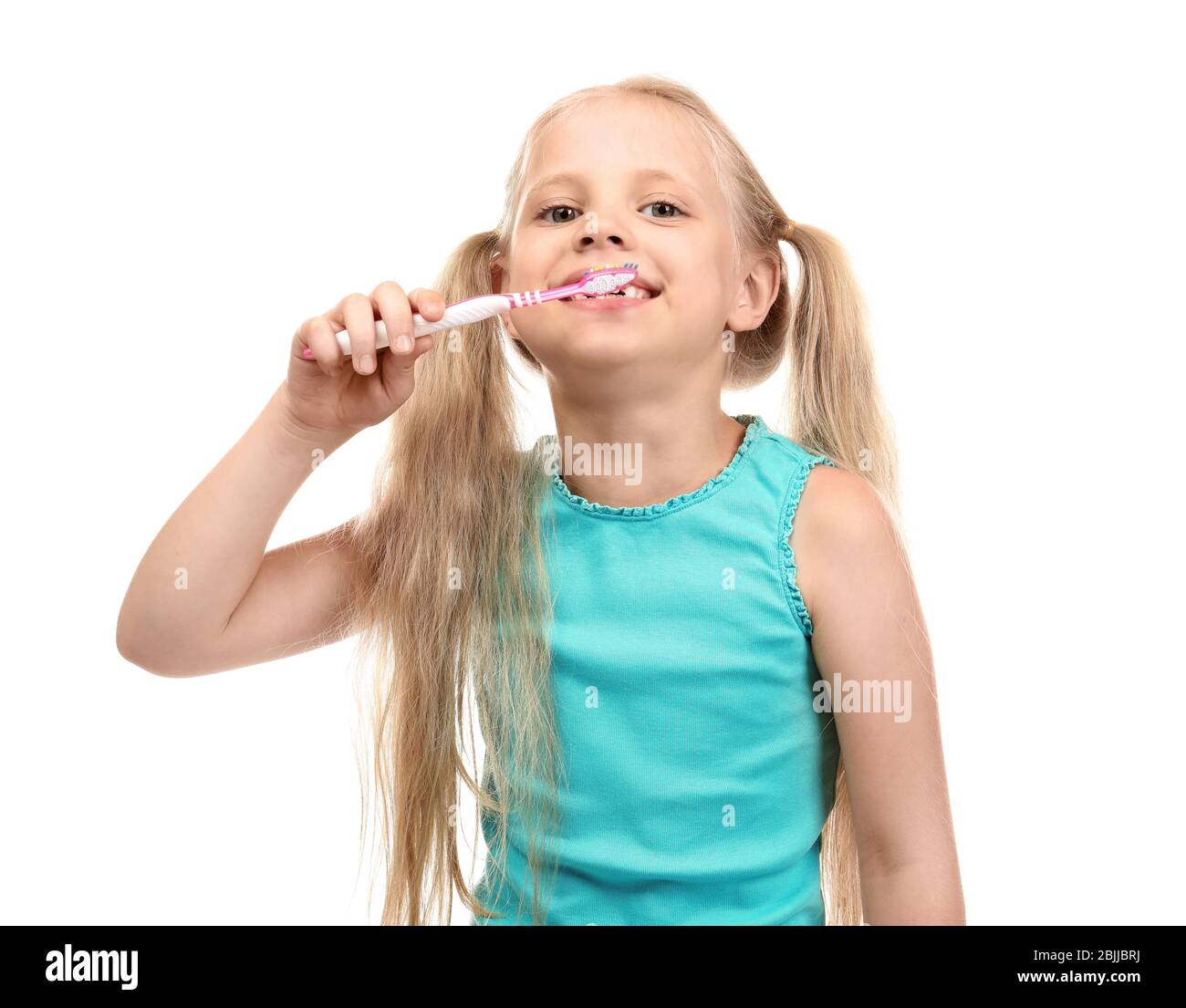 Cute little girl cleaning teeth on white background Stock Photo - Alamy