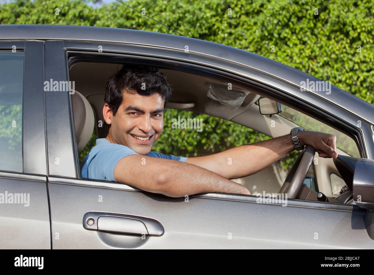 Portrait of a man in his car Stock Photo - Alamy