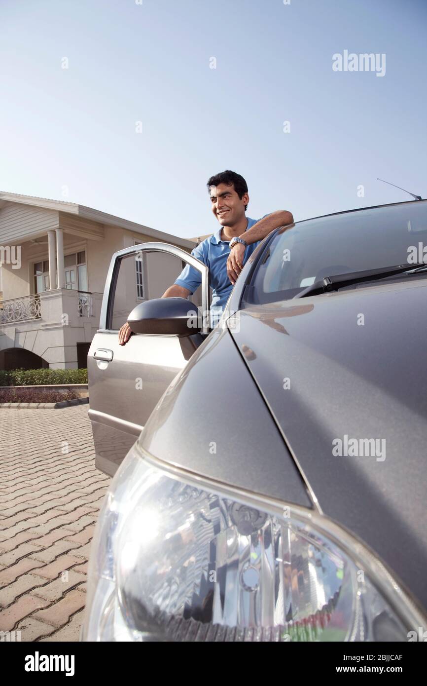 Man standing next to his car Stock Photo - Alamy