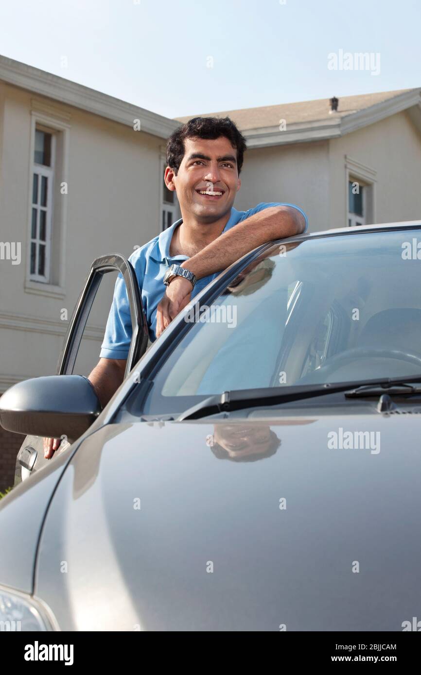 Man standing next to his car Stock Photo - Alamy
