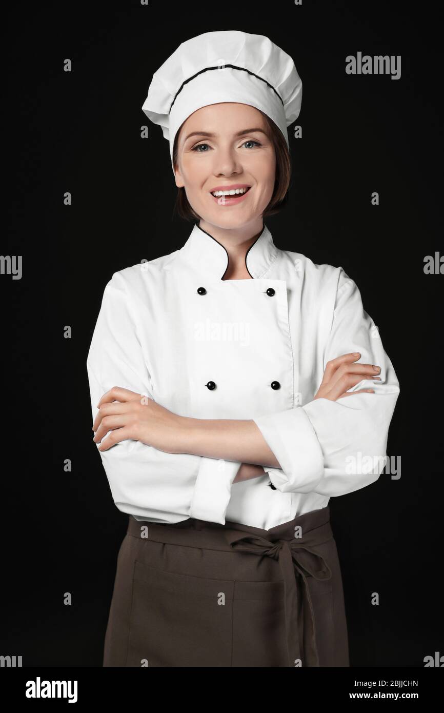 Female chef on dark background Stock Photo - Alamy
