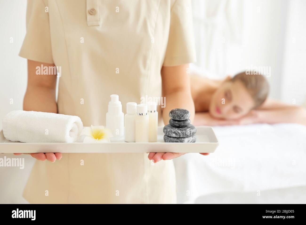 Masseuse holding tray with cosmetics in the spa salon Stock Photo - Alamy
