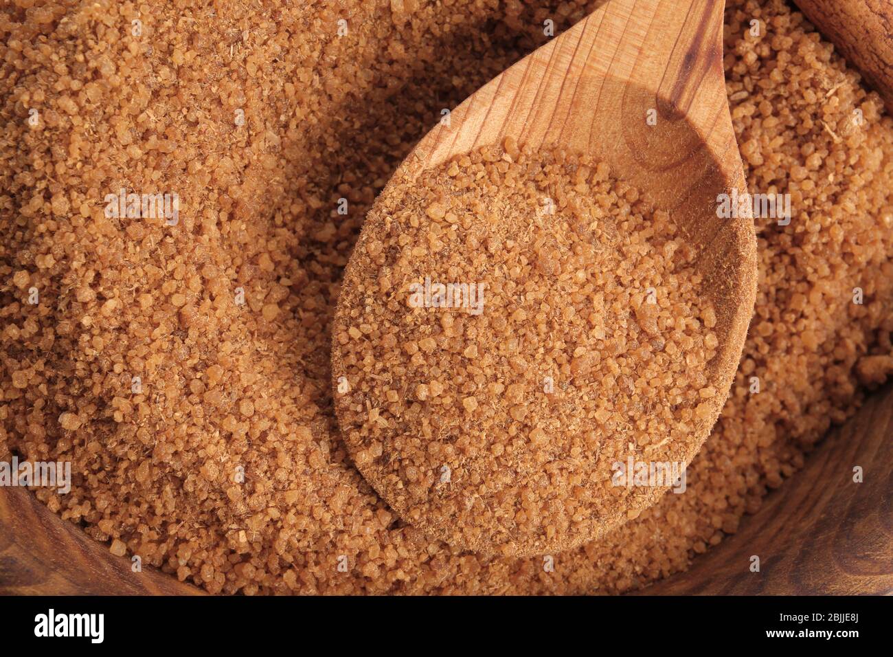 Wooden spoon with sweet cinnamon sugar, closeup Stock Photo - Alamy