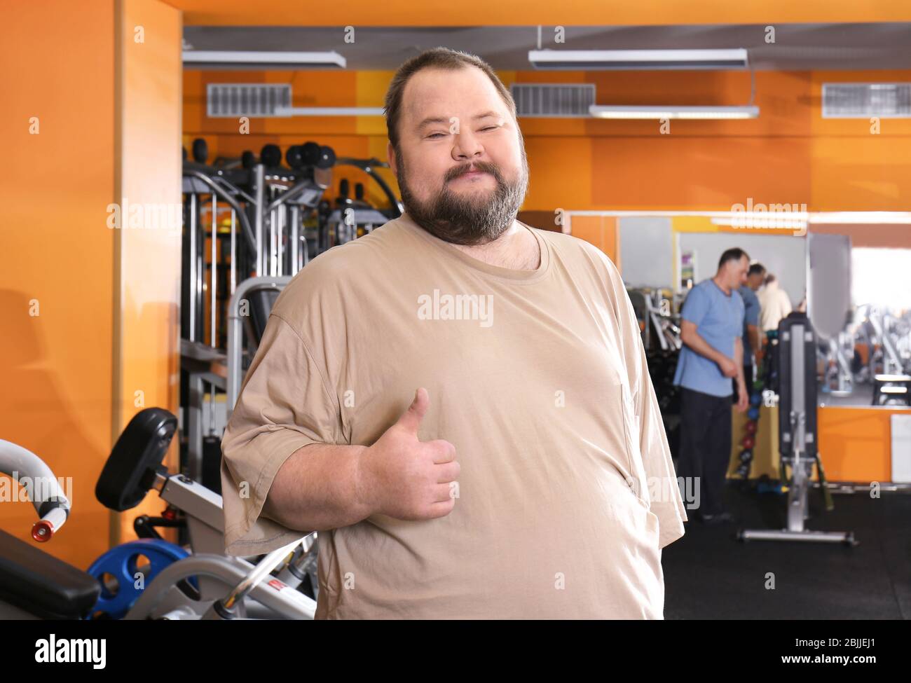 Fat man in gym happy hi-res stock photography and images - Alamy