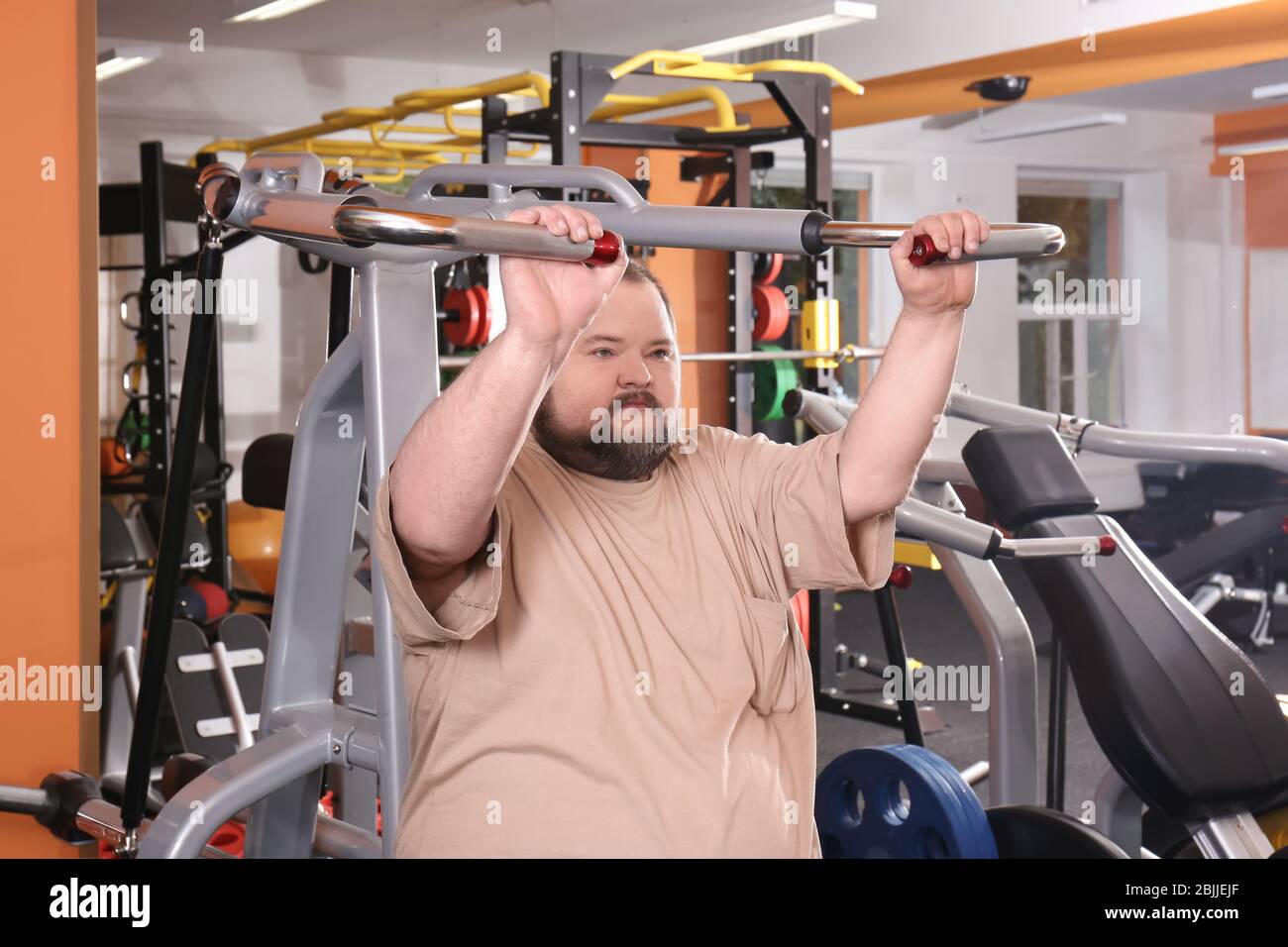 Overweight man training in gym Stock Photo - Alamy