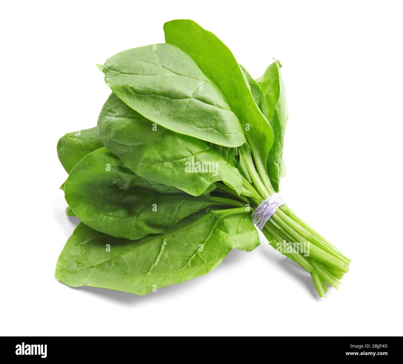 Fresh bunch of spinach on white background Stock Photo - Alamy