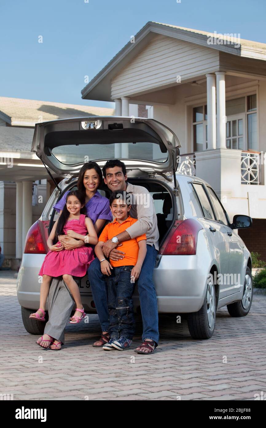 Family sitting at the back of a car Stock Photo - Alamy