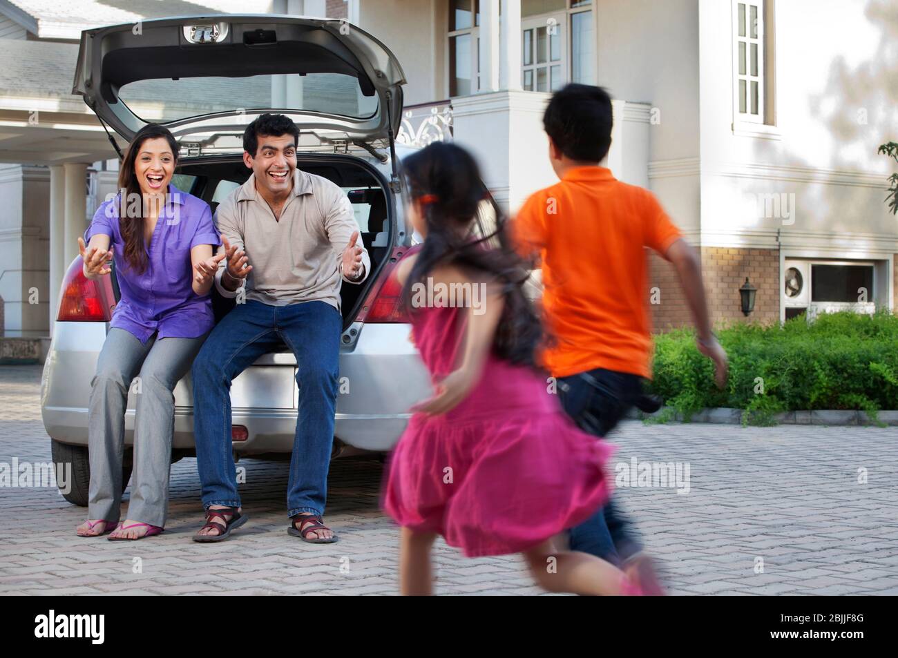 Kids running to their parents Stock Photo - Alamy