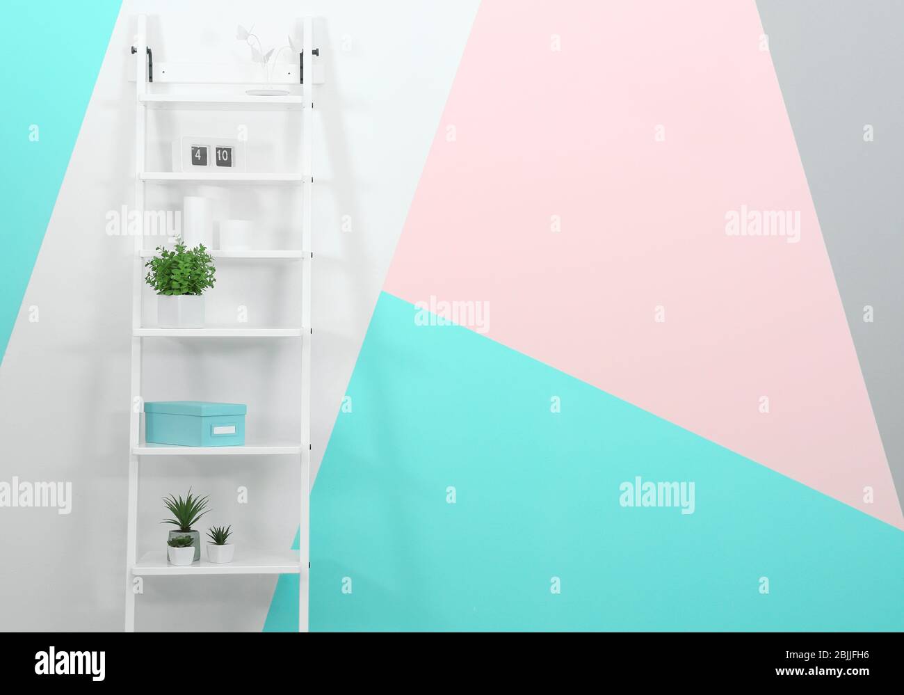 Trendy white bookcase near wall with mint color Stock Photo - Alamy