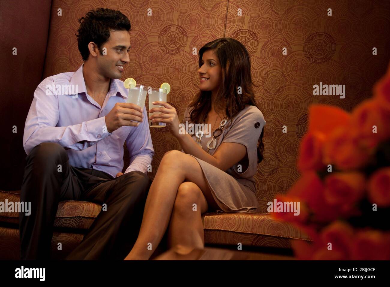 Couple having drinks in a restaurant Stock Photo - Alamy