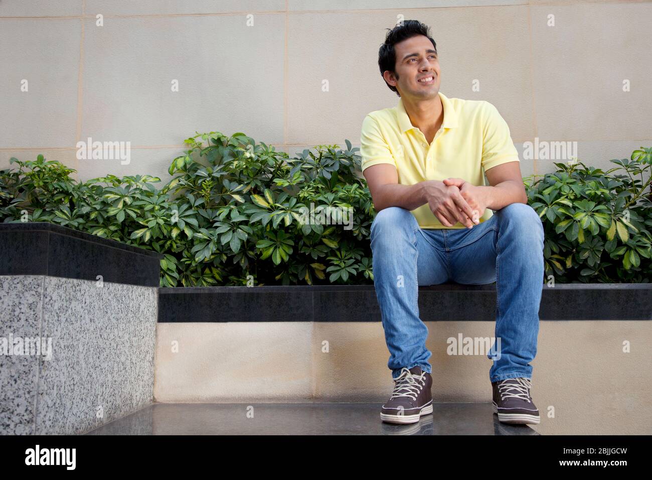 Man sitting outside Stock Photo - Alamy