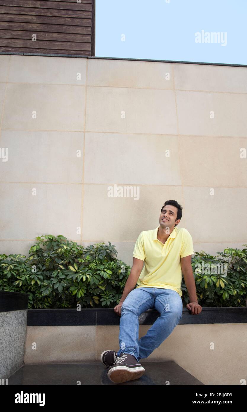 Man sitting outside Stock Photo - Alamy