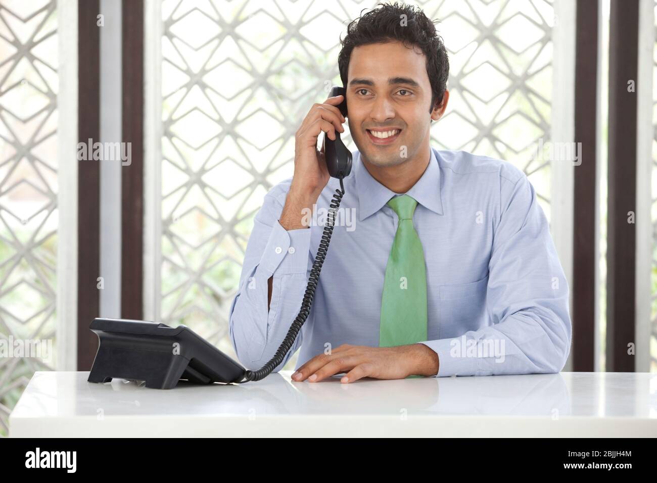 Executive talking on a phone Stock Photo - Alamy