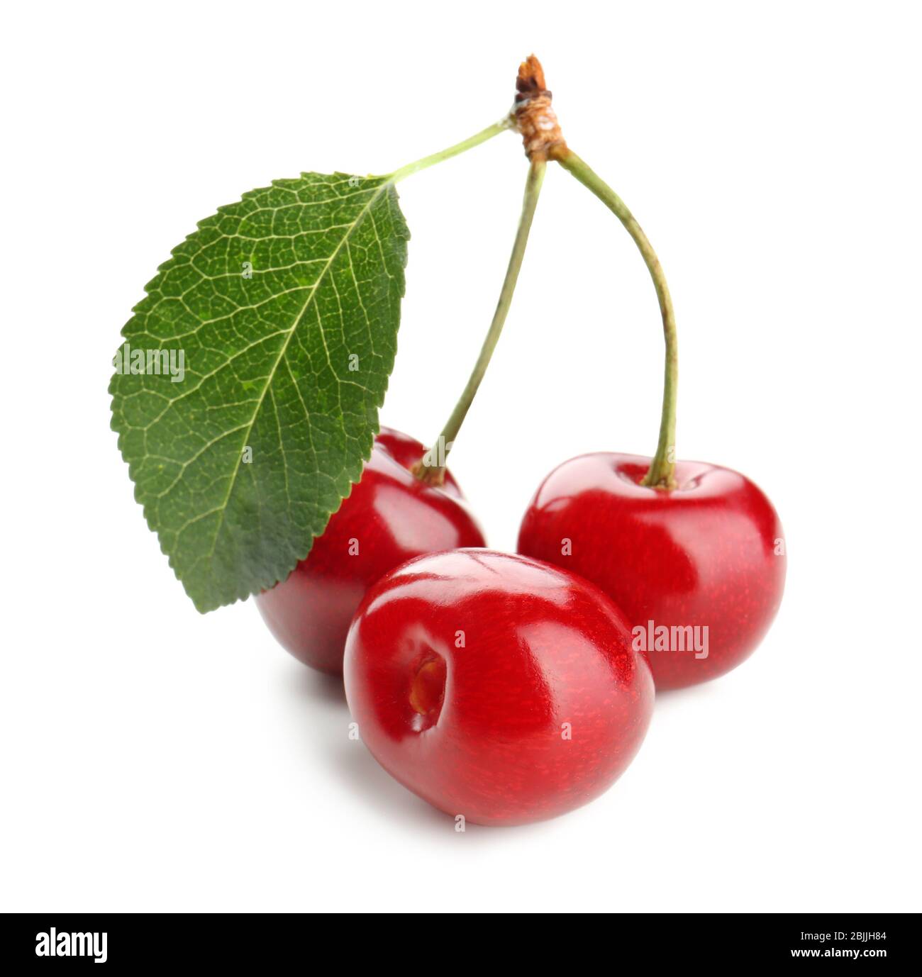 Sweet red cherries with leaf, isolated on white Stock Photo - Alamy