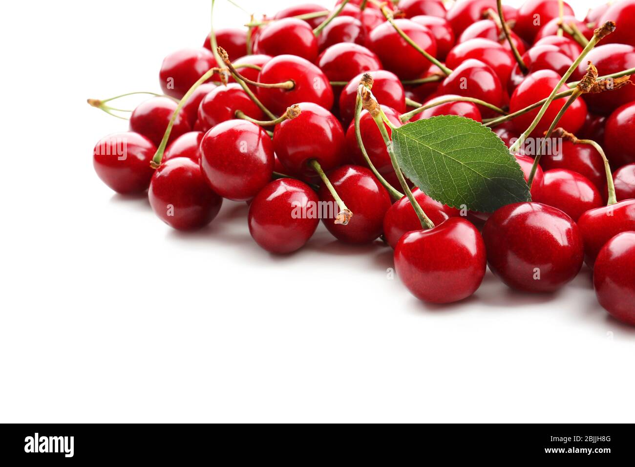 Sweet red cherries scattered on white background Stock Photo - Alamy