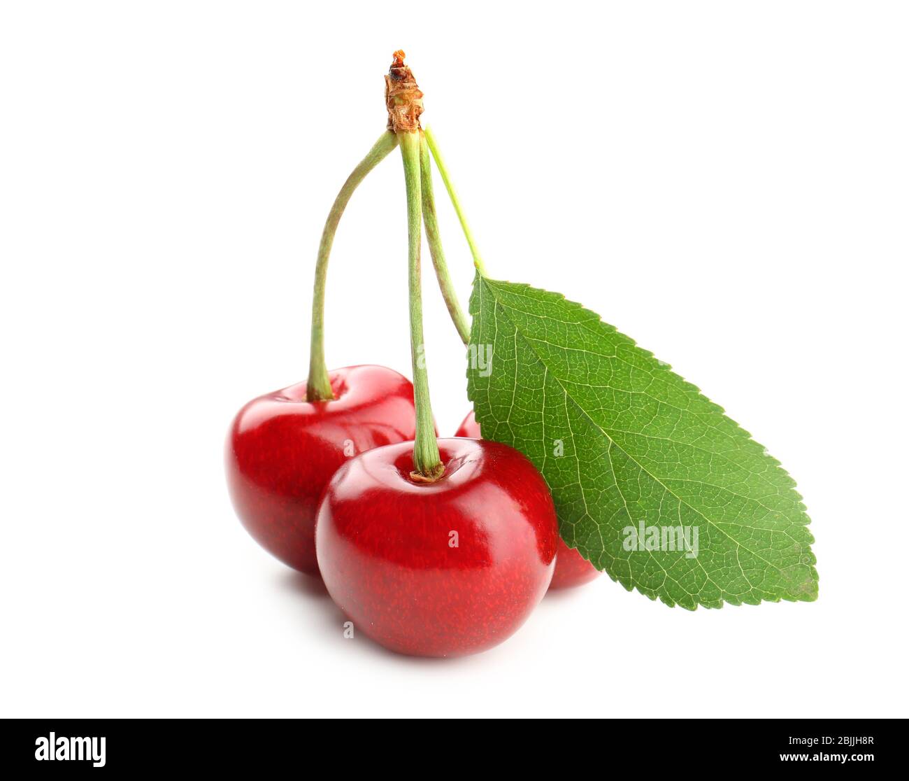 Sweet red cherries with leaf, isolated on white Stock Photo - Alamy