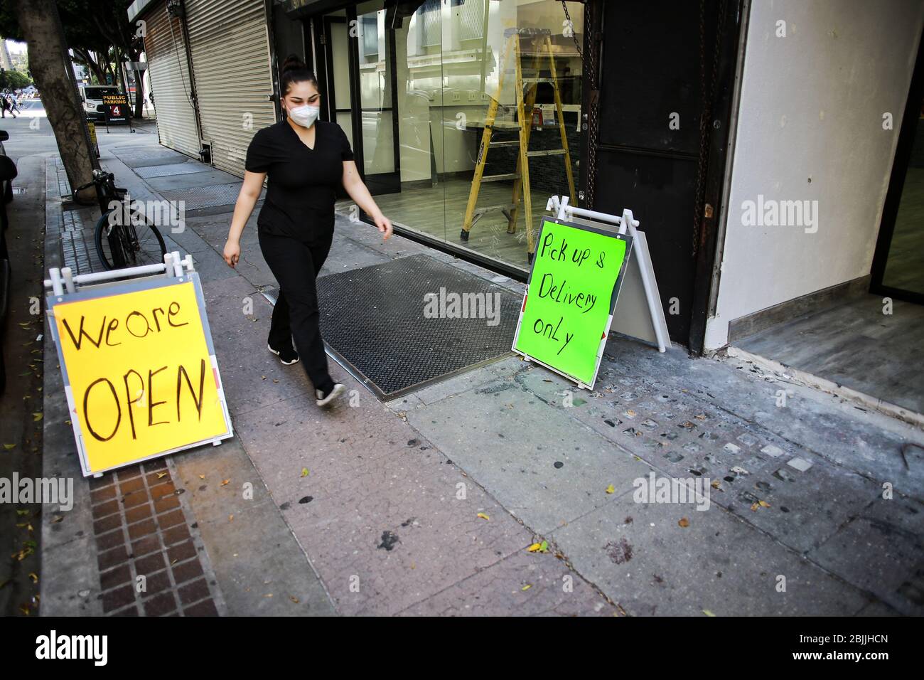 Los Angeles, United States. 23rd Apr, 2020. A pedestrian walks past ...