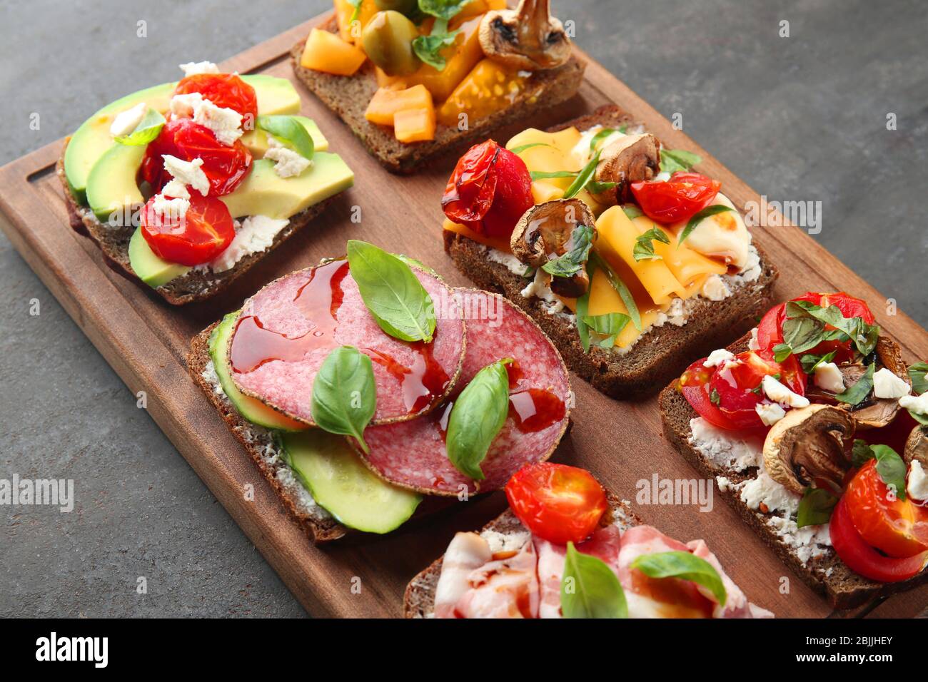 Composition with tasty homemade sandwiches on wooden board Stock Photo ...