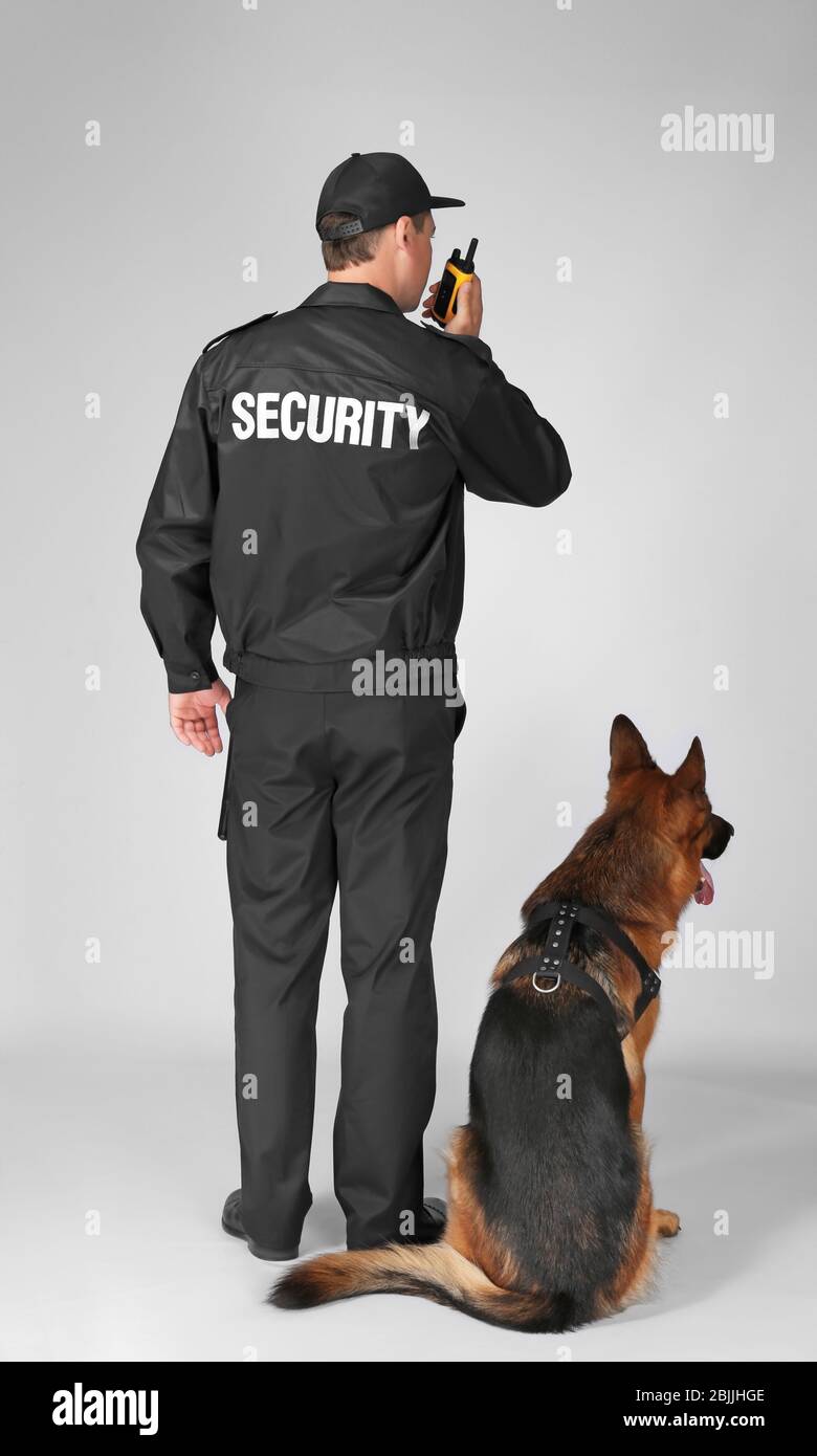Security guard with dog on white background Stock Photo - Alamy