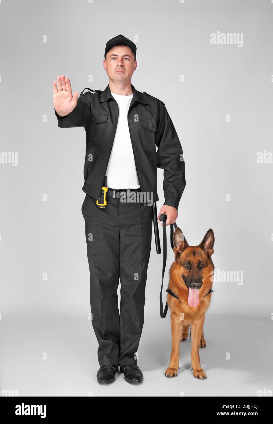 Security guard with dog on white background Stock Photo - Alamy