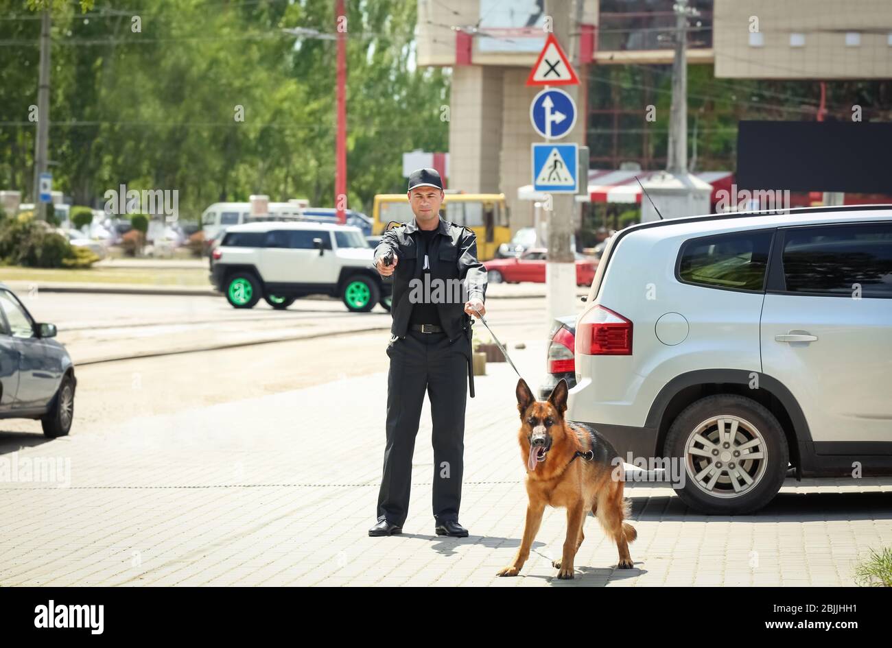 Security guard with dog, outdoors Stock Photo - Alamy