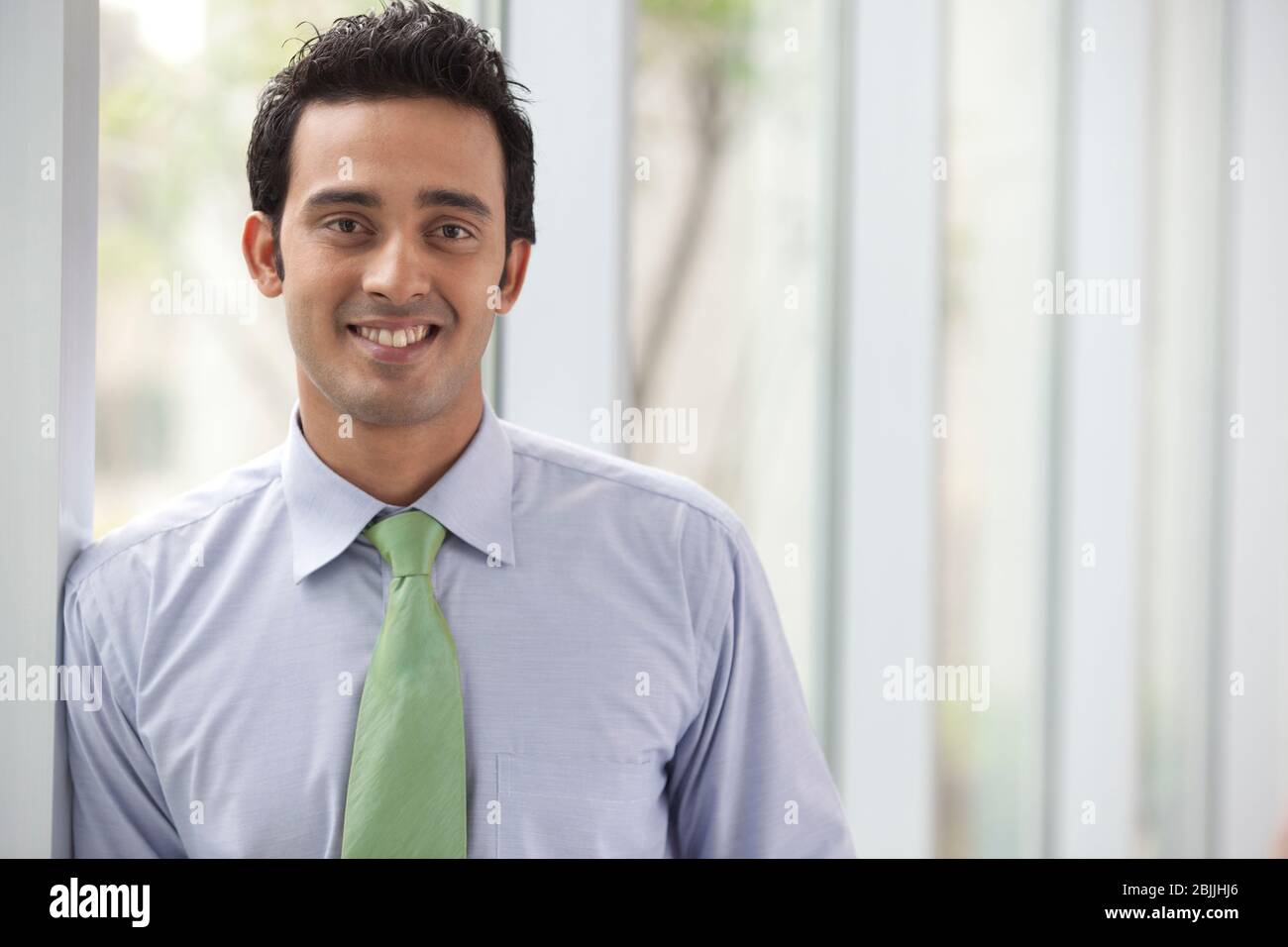 Portrait of an executive smiling Stock Photo - Alamy