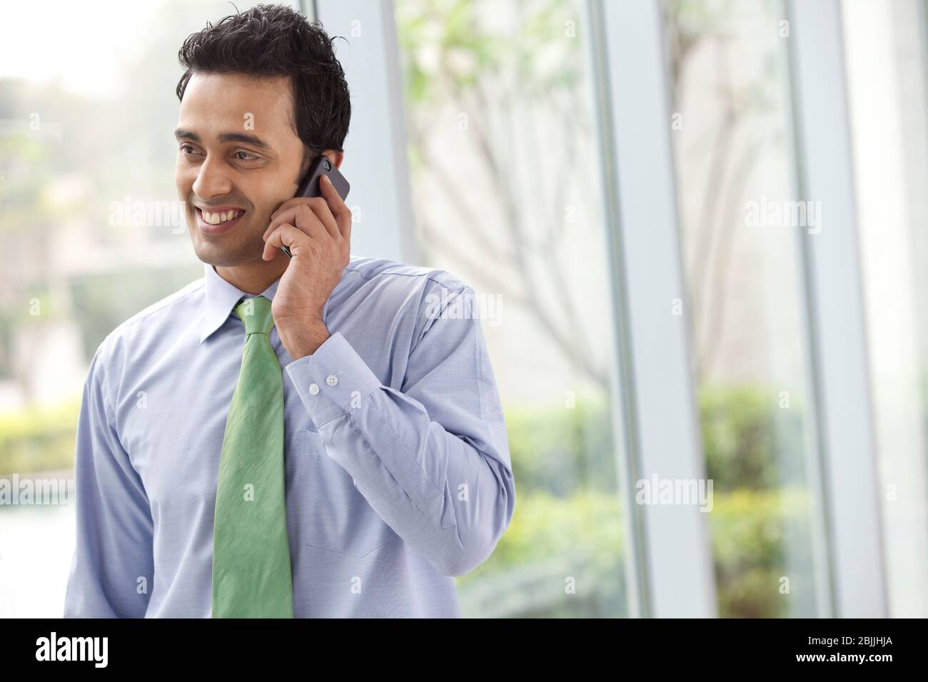 Executive talking on a mobile phone Stock Photo - Alamy
