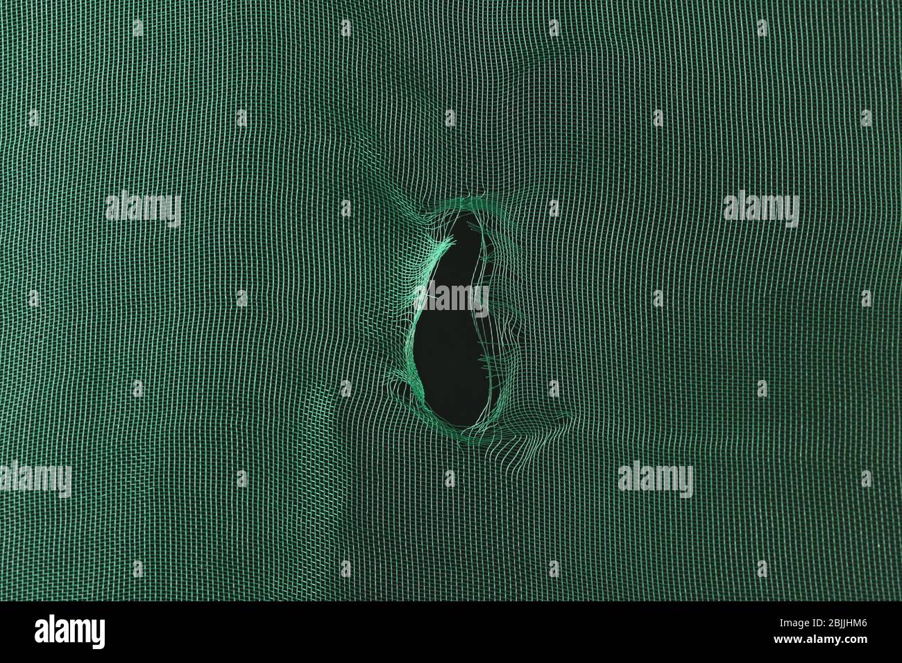 Torn window screen, closeup Stock Photo - Alamy