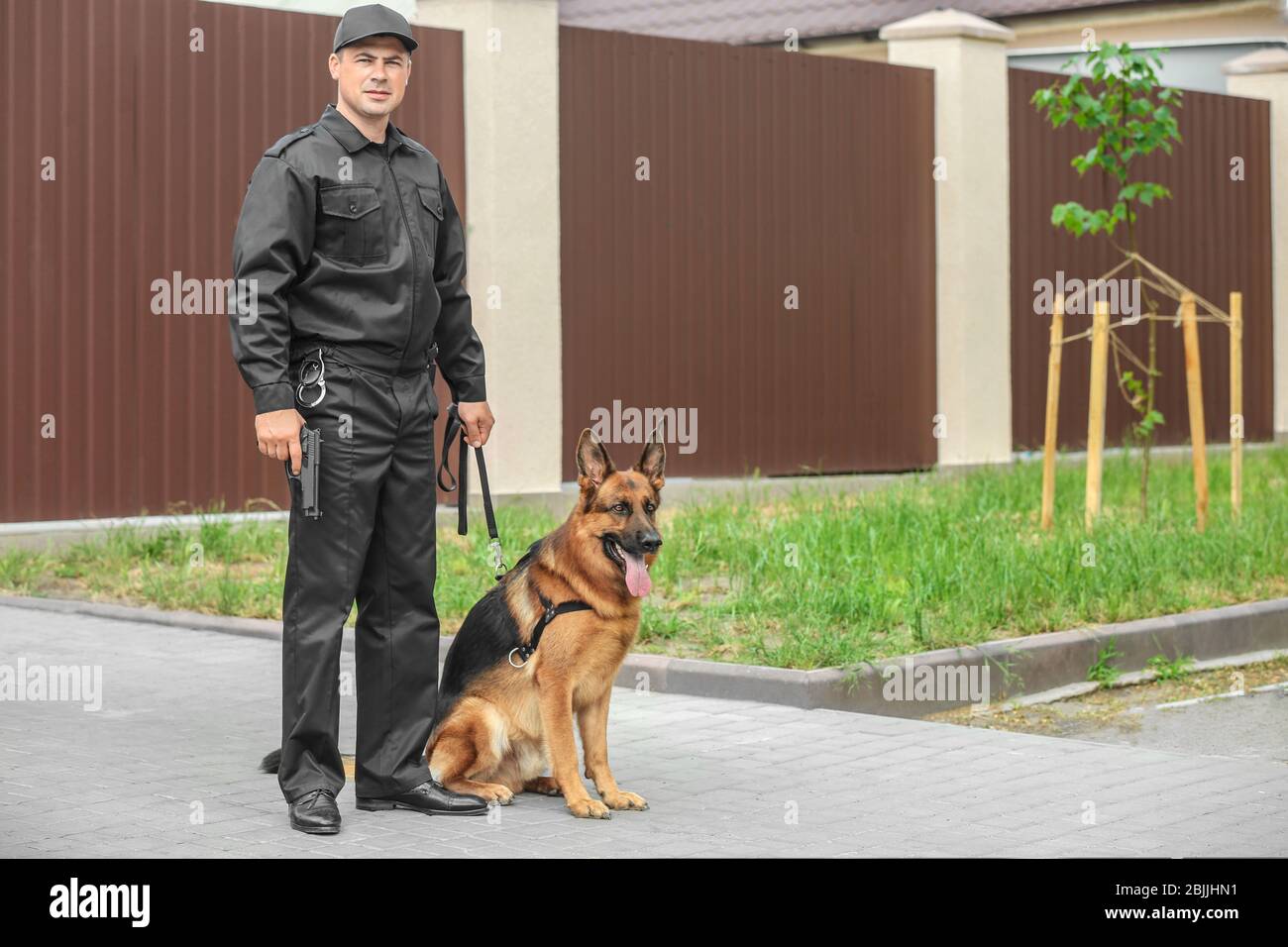 Security guard with dog, outdoors Stock Photo - Alamy