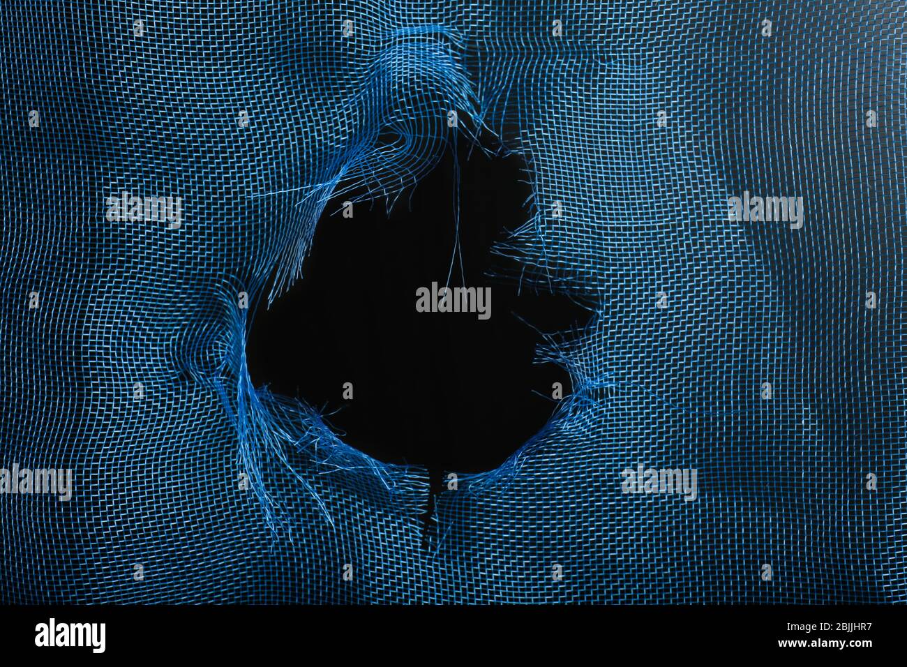Torn window screen, closeup Stock Photo - Alamy