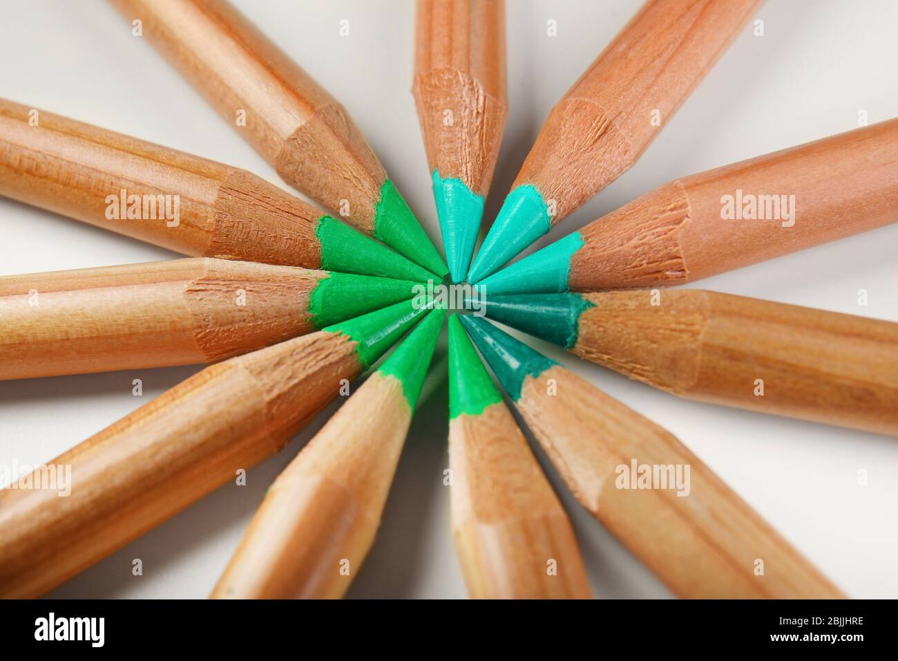 Pencils of green shades on white background Stock Photo - Alamy