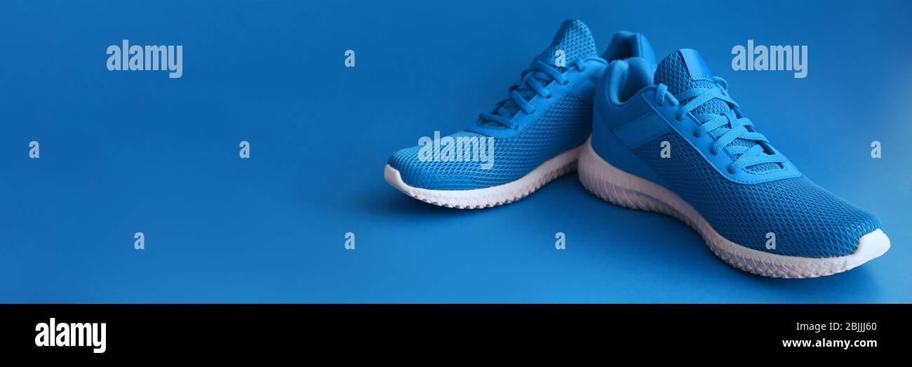 Colorful sport shoes on blue color backround Stock Photo - Alamy