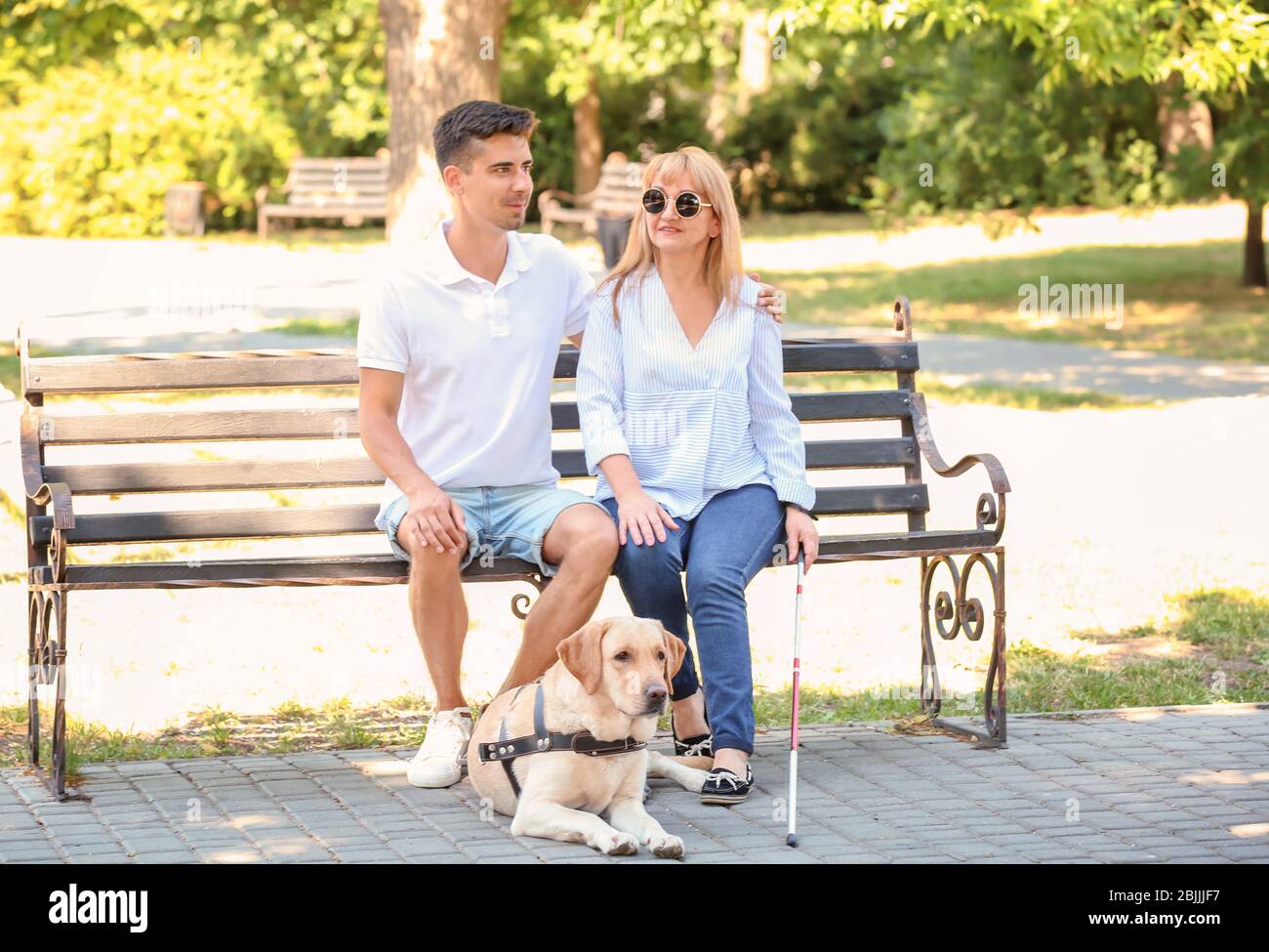 Man lying on bench with his dog bench hi-res stock photography and ...