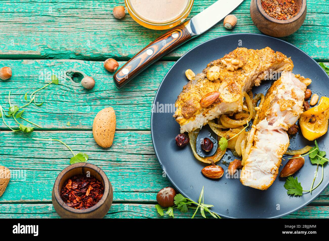 Roasted piece of silver carp with nut.Tasty baked fish on plate Stock ...