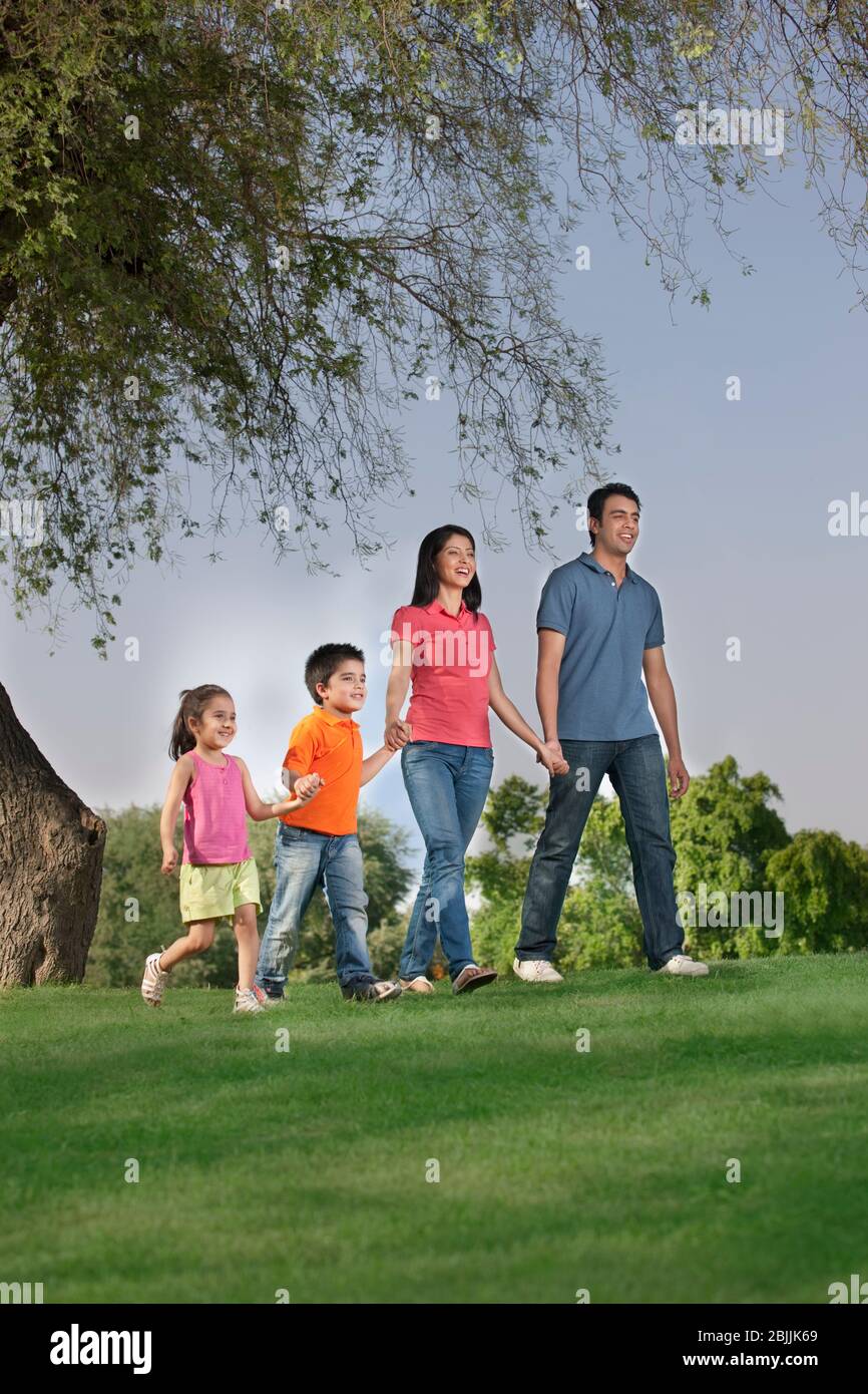 Family walking in a park Stock Photo - Alamy