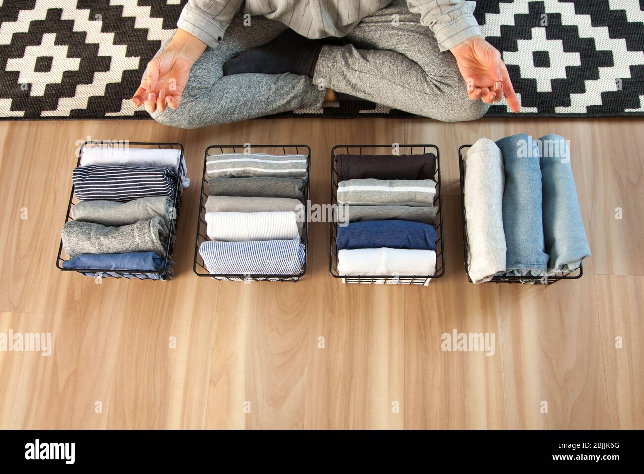 Vertical tidying up storage. Neatly folded clothes neutral colors in ...