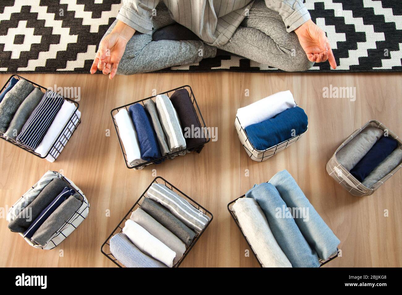 Vertical tidying up storage. Neatly folded clothes neutral colors in ...