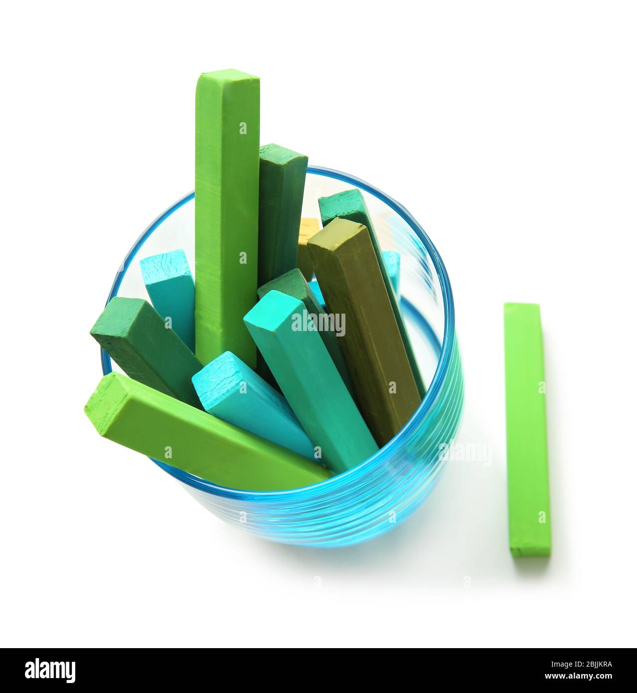 Bright green chalk in glass on white background Stock Photo - Alamy