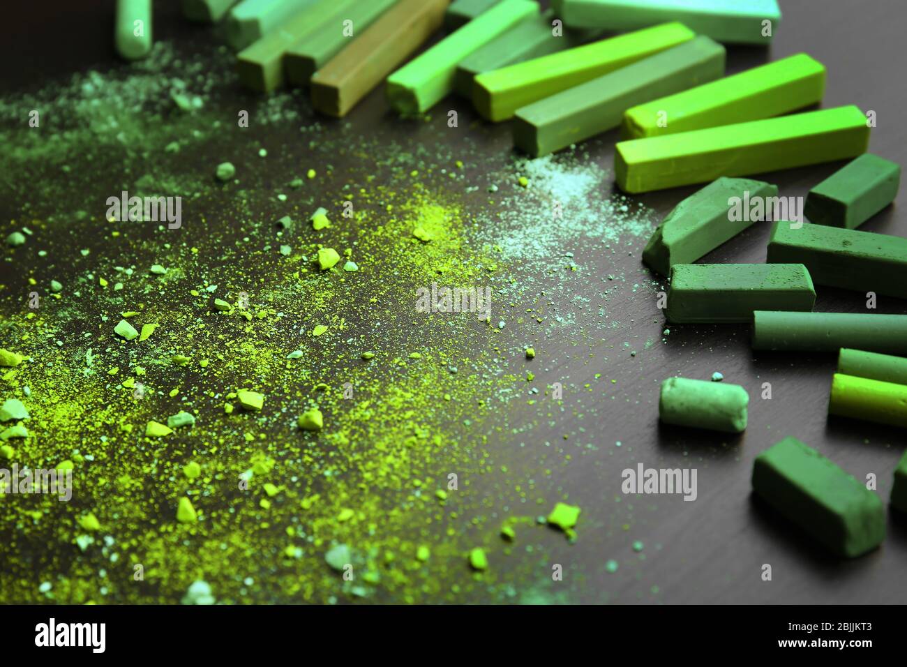 Bright green chalk crushed on black background Stock Photo - Alamy