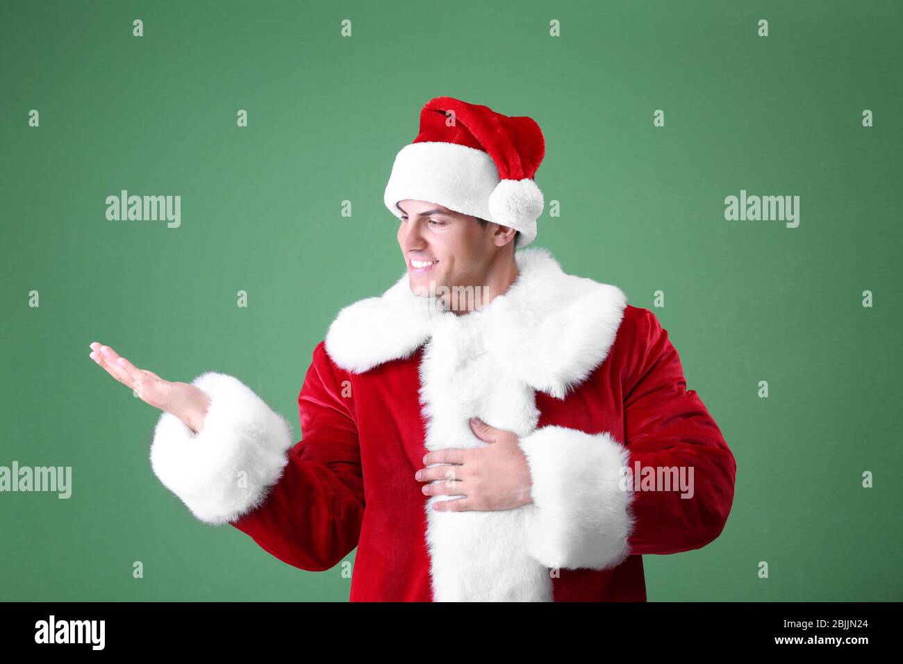 Handsome man in Santa Claus costume on color background Stock Photo - Alamy