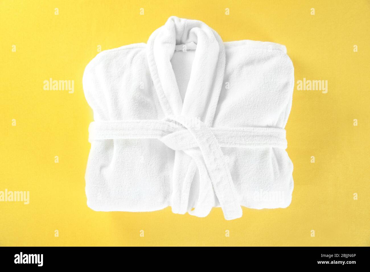 Folded bathrobe on color background Stock Photo - Alamy
