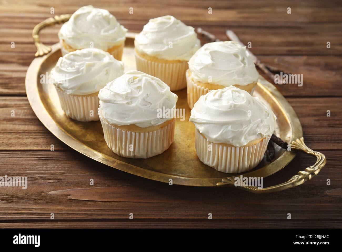Tasty vanilla cupcakes on metal tray Stock Photo - Alamy